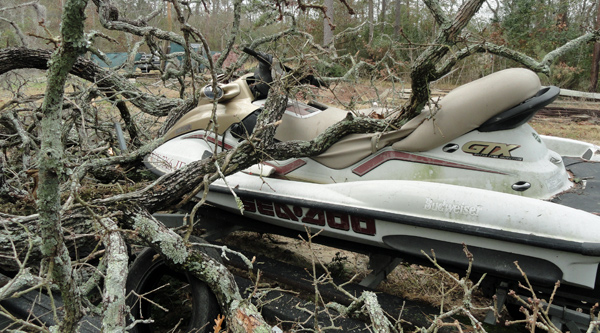 Gusty winds knock over tree, damage charity’s Jet Ski | khou.com